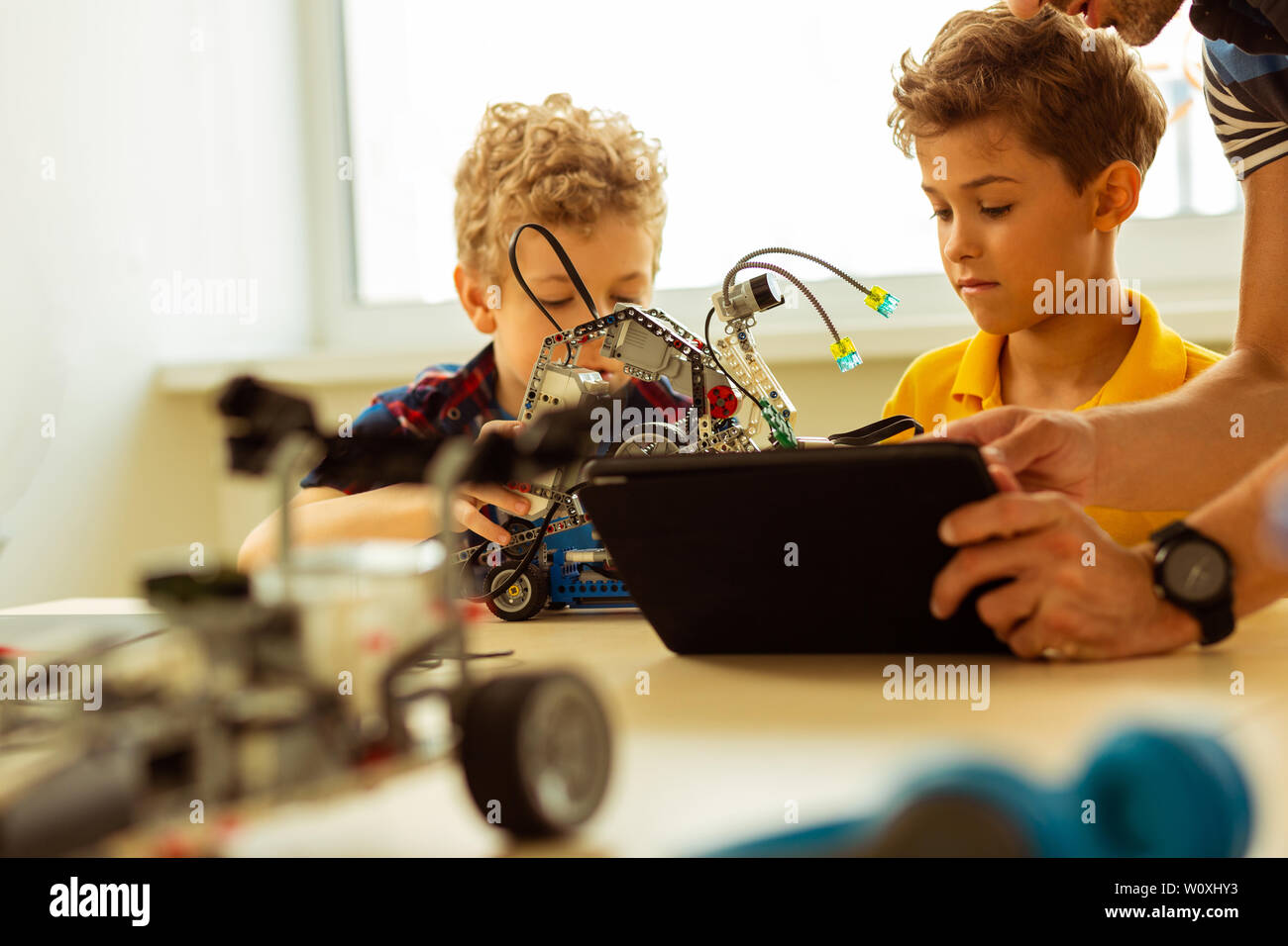Digital device. Close up of a tablet in male hands being used during ...
