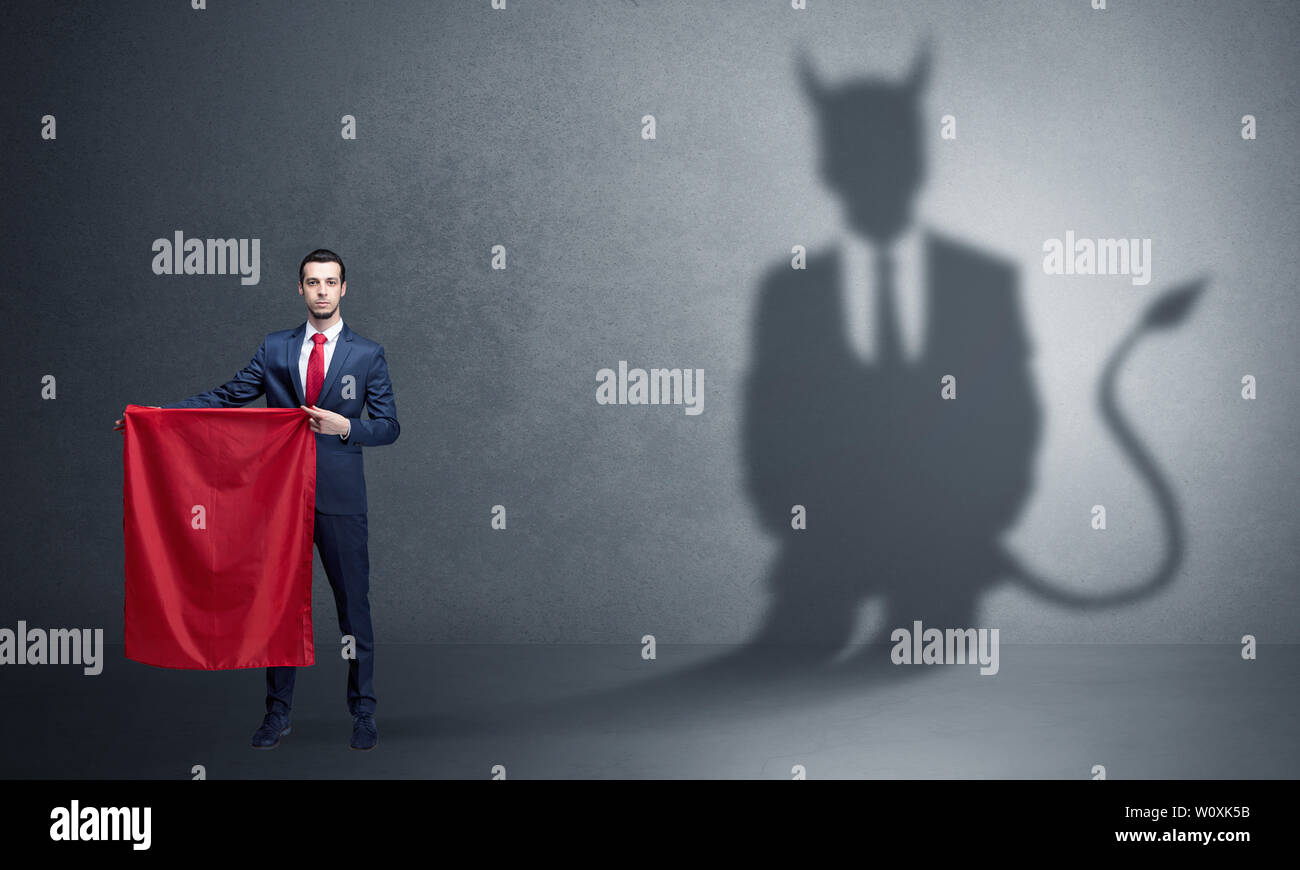 Businessman standing with red cloth in his hand and devil shadow on the ...