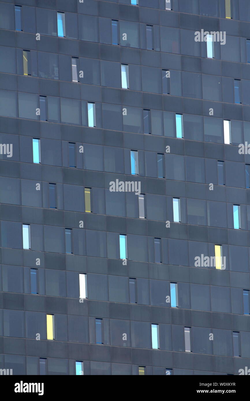 Tall narrow colorful windows on new dark modern office building texture ...