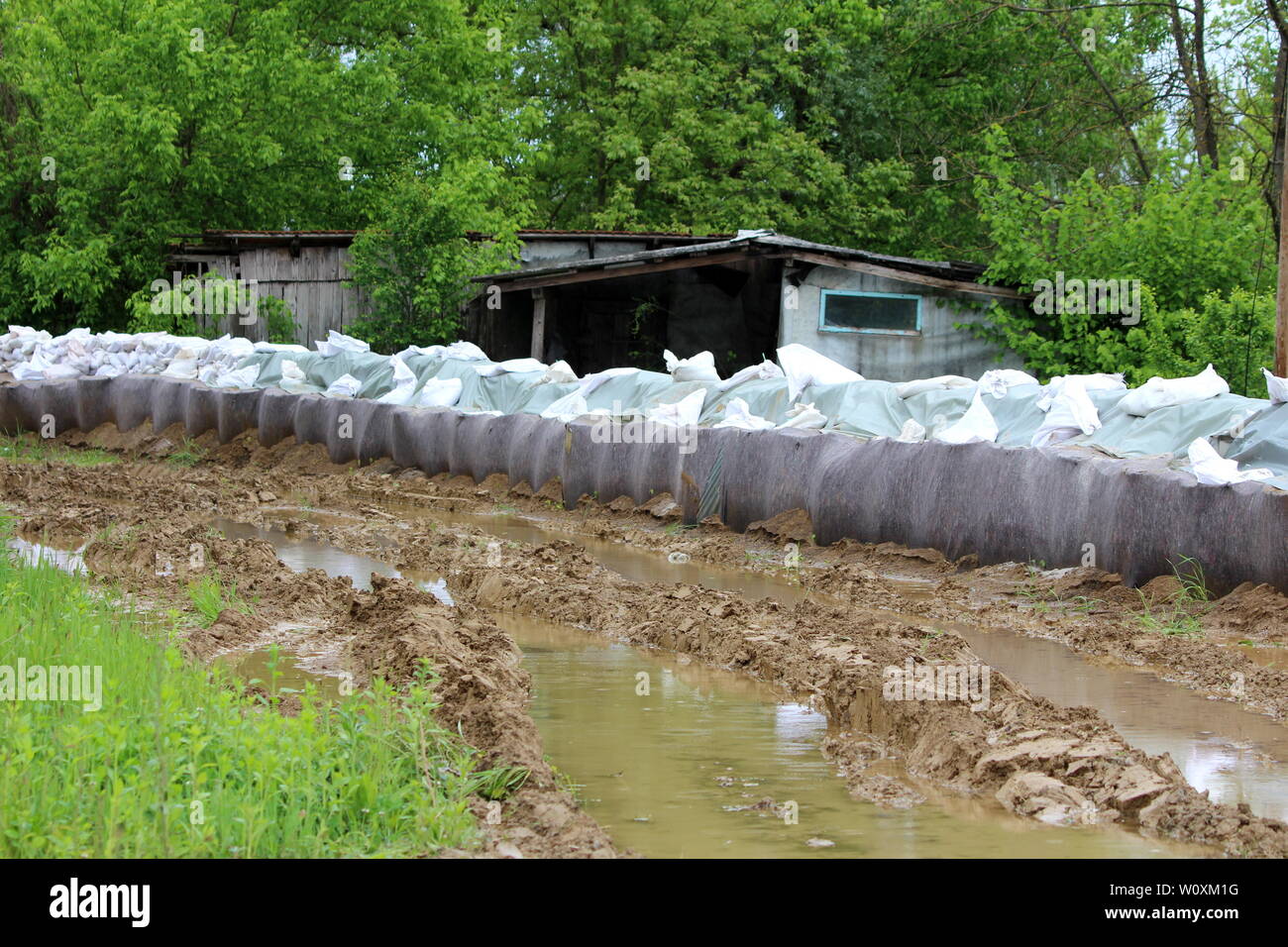 Temporary flood protection wall made of box barriers and sandbags ...