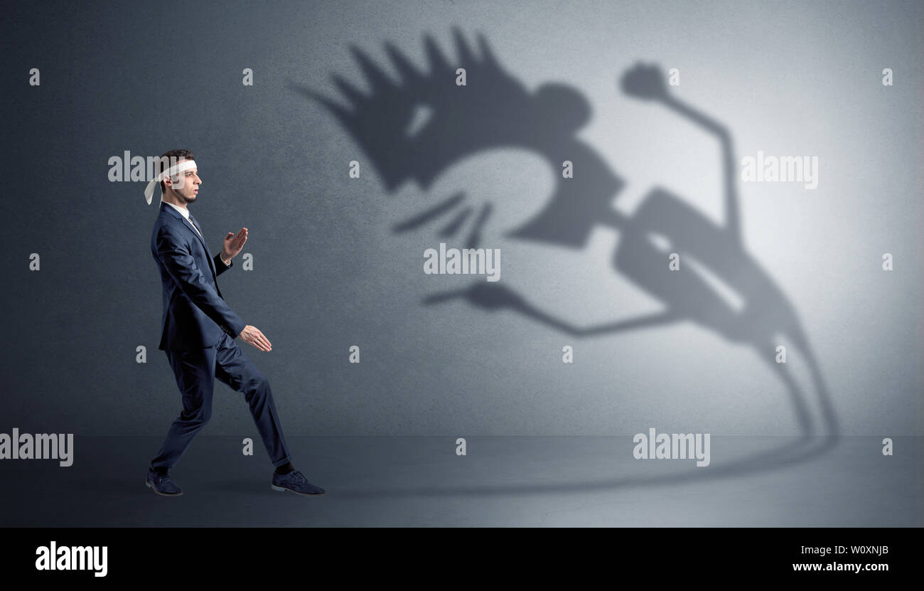 Young karate man fighting with a big black scary shadow Stock Photo - Alamy