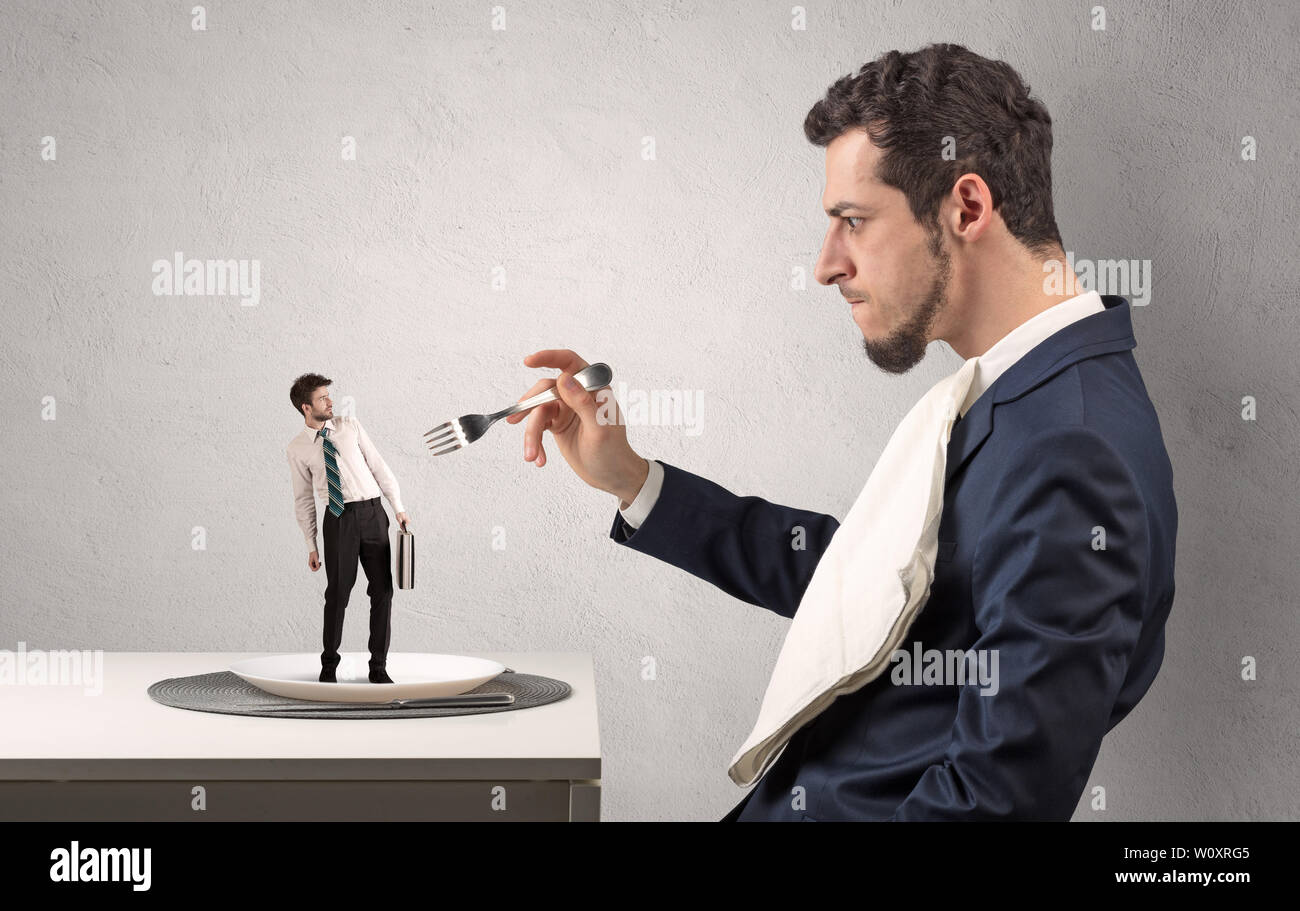 Tiny scared weak businessman almost devoured by great power Stock Photo ...