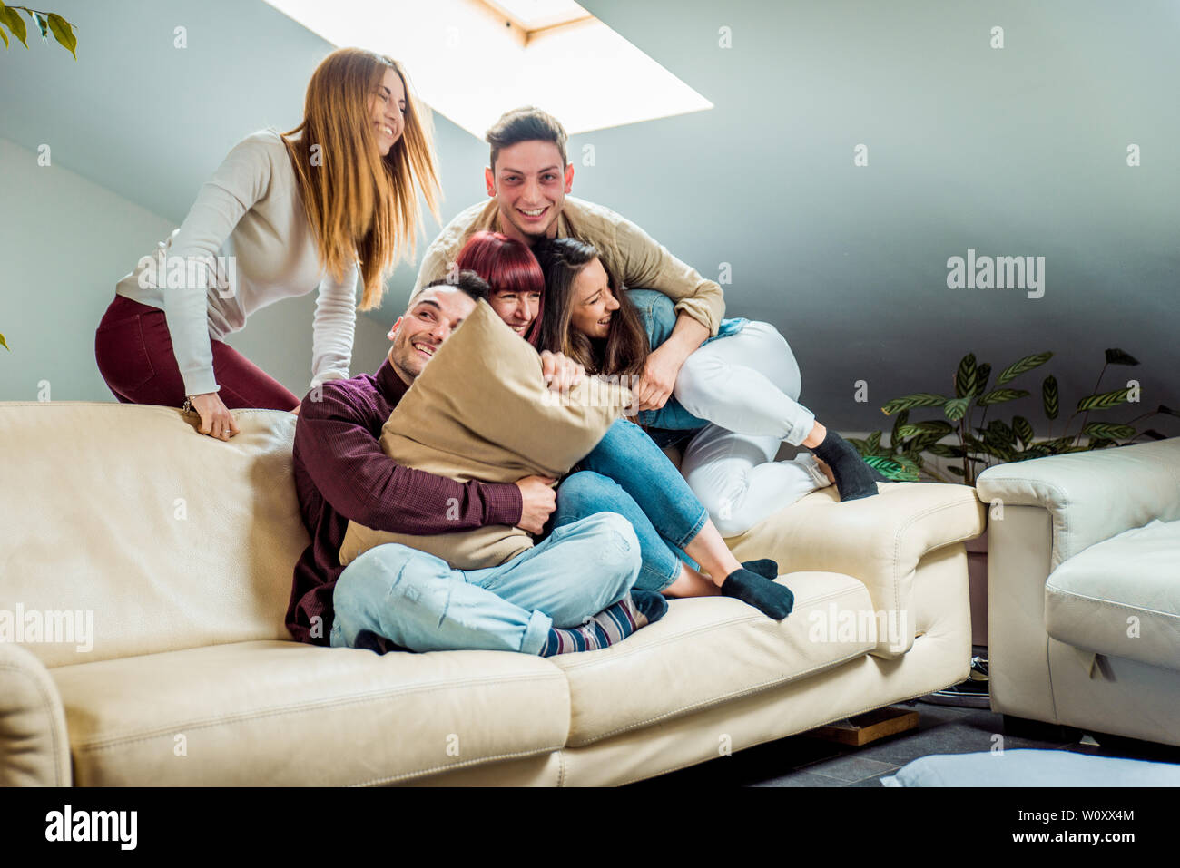 Group of happy friends bonding at home - Young adults having party and ...
