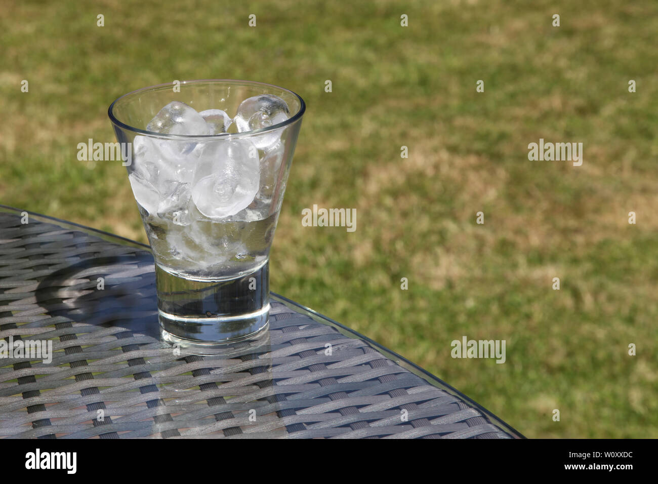 Ice melting concept - Part of a Series of images 2of7 showing glass of ...
