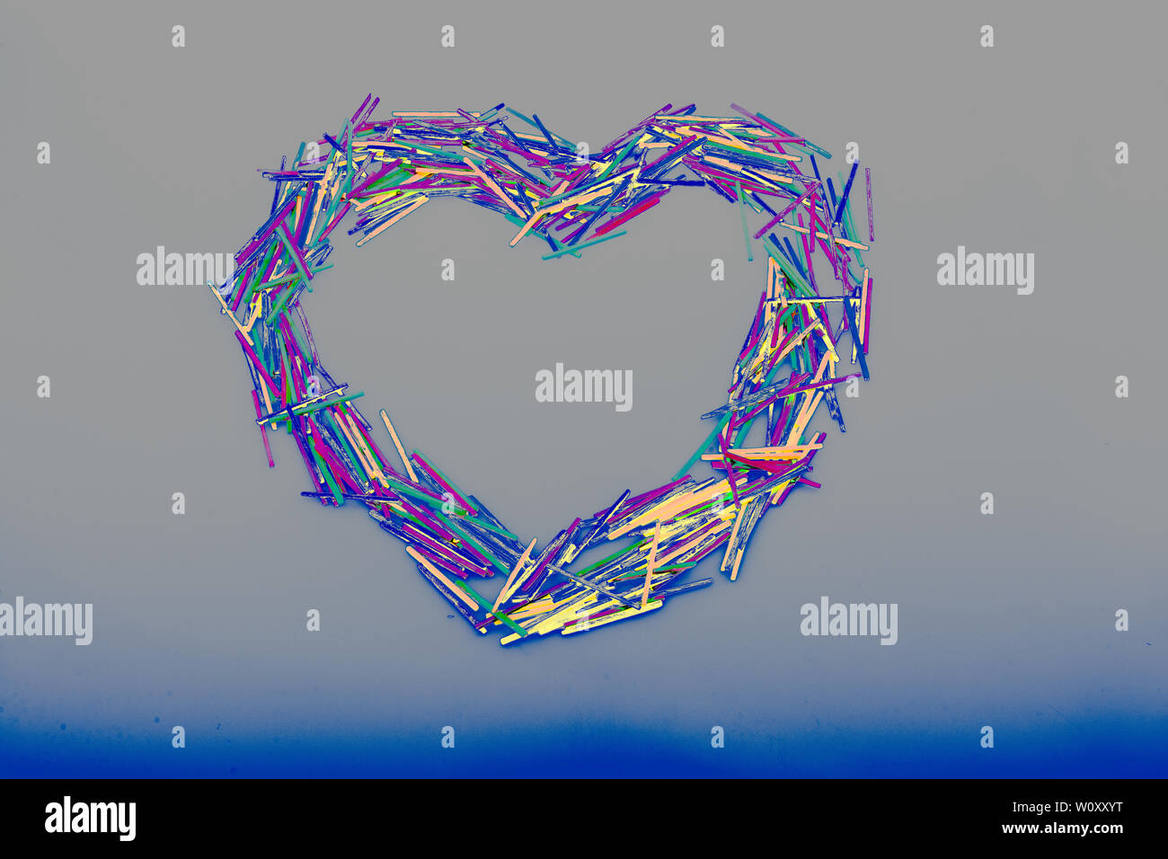 Coloured wooden sticks form heart shape on white background Stock Photo ...