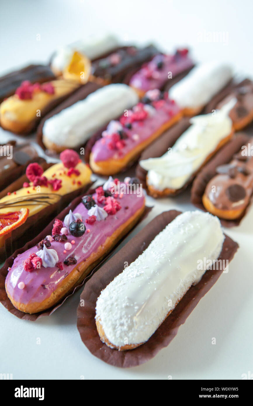 Set of several eclairs with various fillings and design isolate on a ...