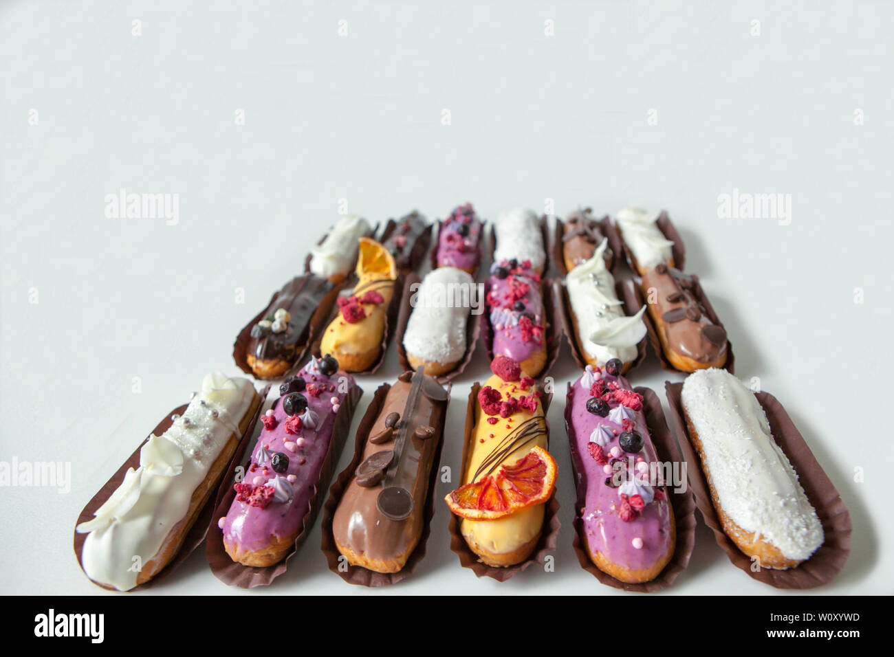 Set of several eclairs with various fillings and design isolate on a ...