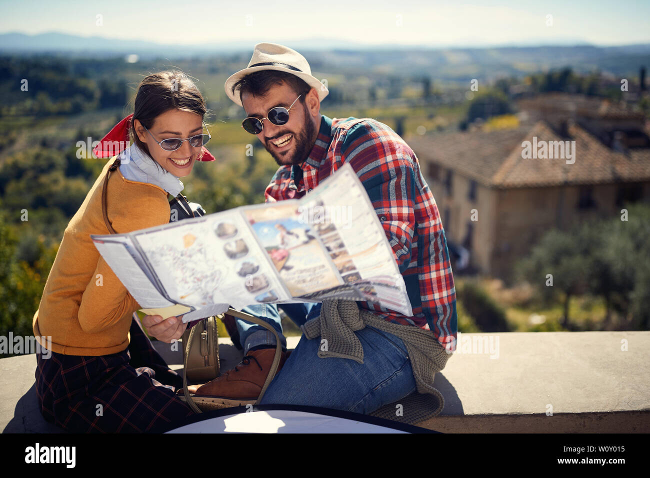 Smiling tourist man and girl using map as guide on journey time Stock ...