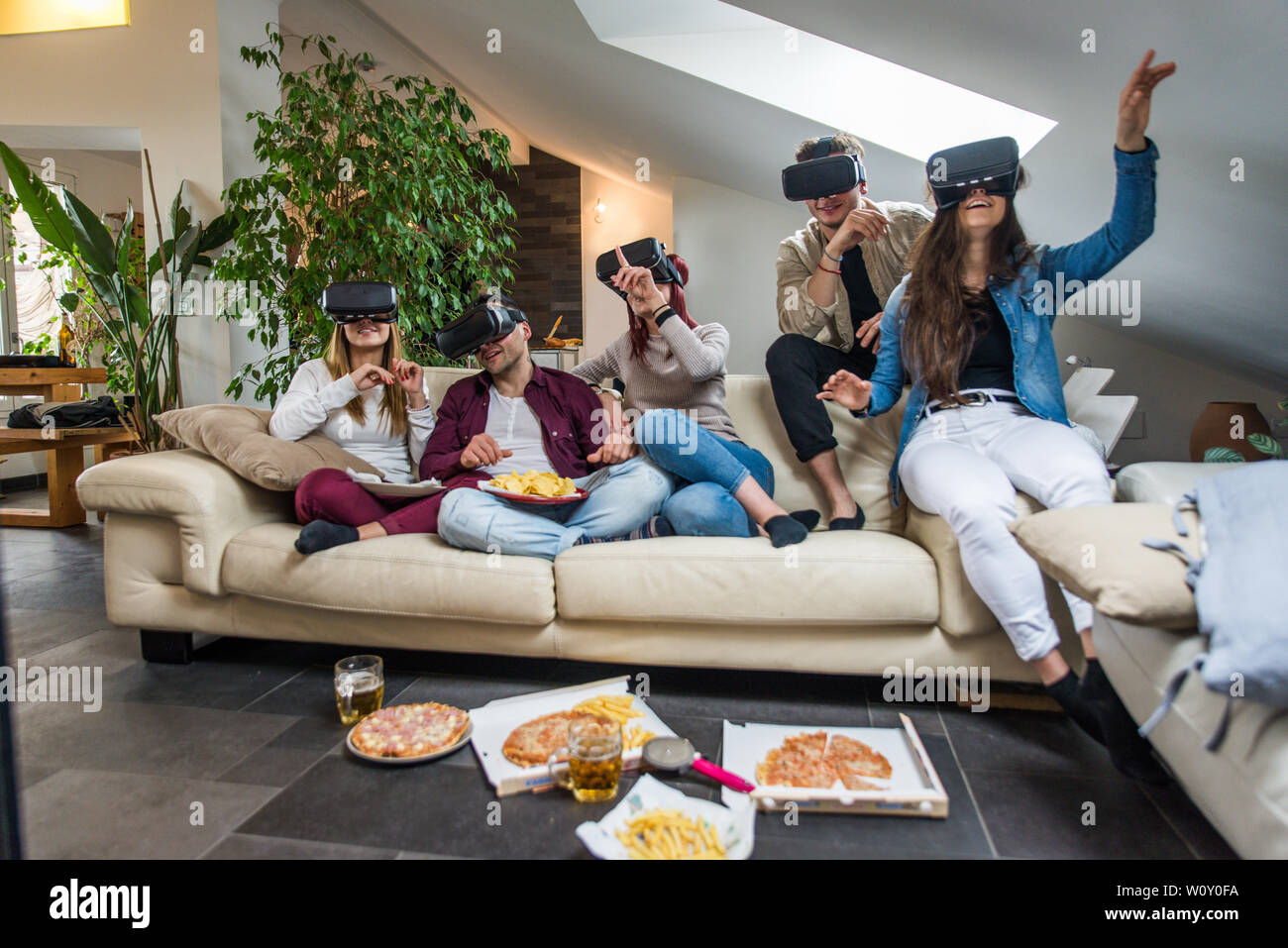Group of happy friends bonding at home - Young adults having party and ...