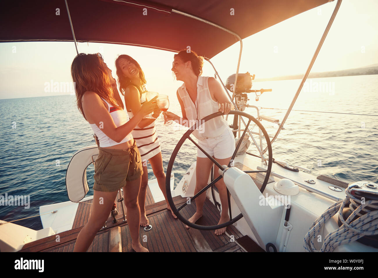 young beautiful women have fun on the yacht at sunset Stock Photo - Alamy