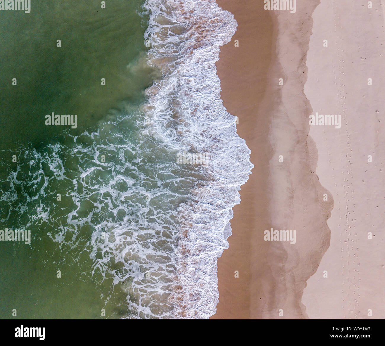 Bird eye perspective of waves hitting the beach on the Swahili coast ...