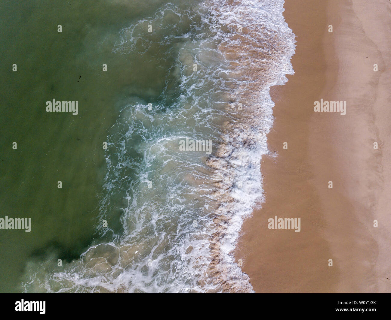 Bird eye perspective of waves hitting the beach on the Swahili coast ...