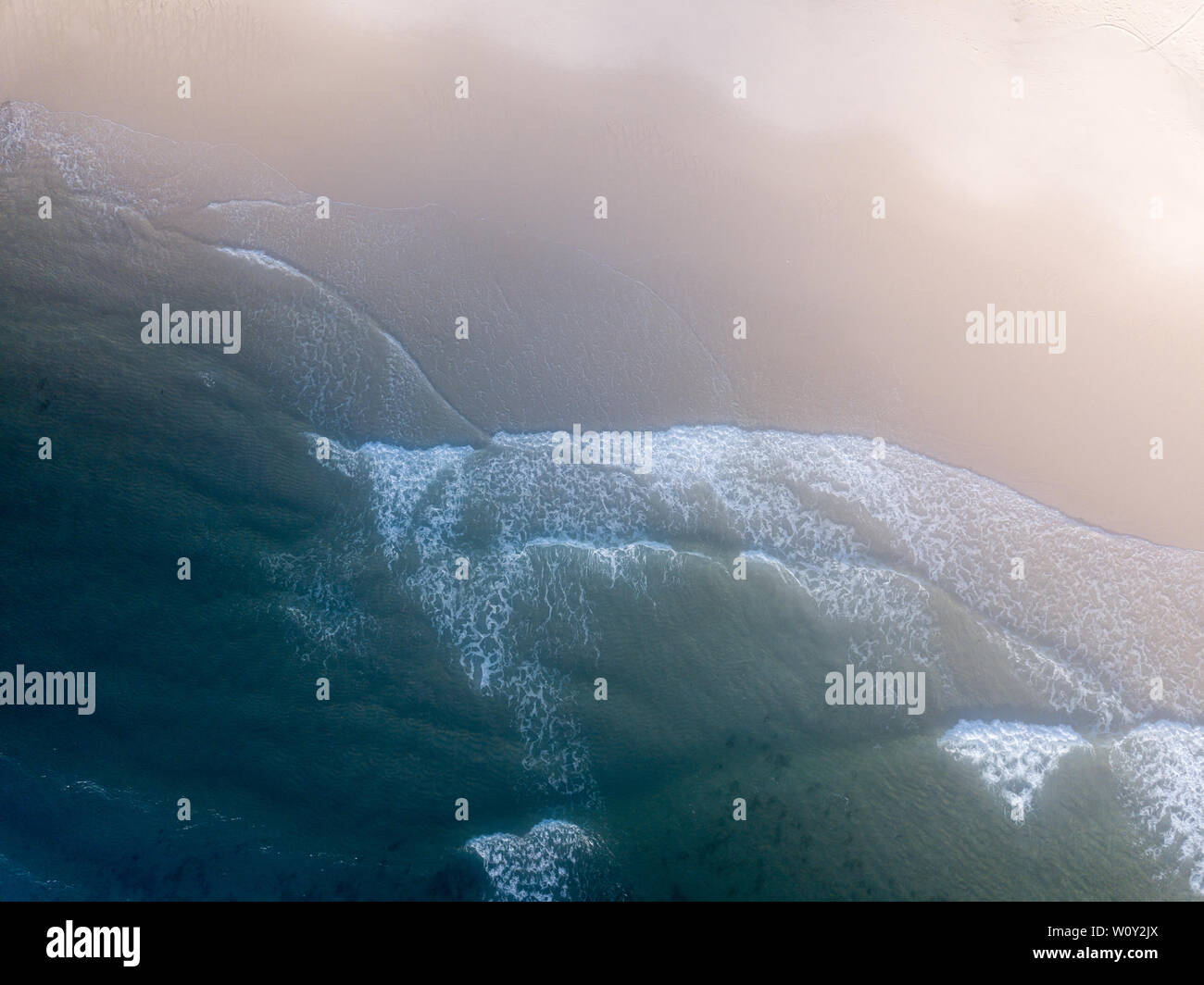 Bird eye perspective of waves hitting the beach on the Swahili coast ...