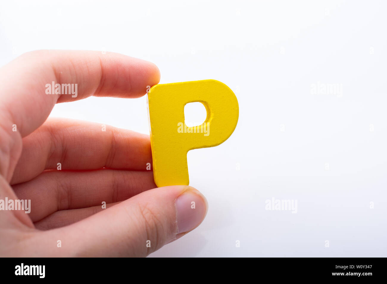 Hand holding letter cube P of made of wood Stock Photo - Alamy