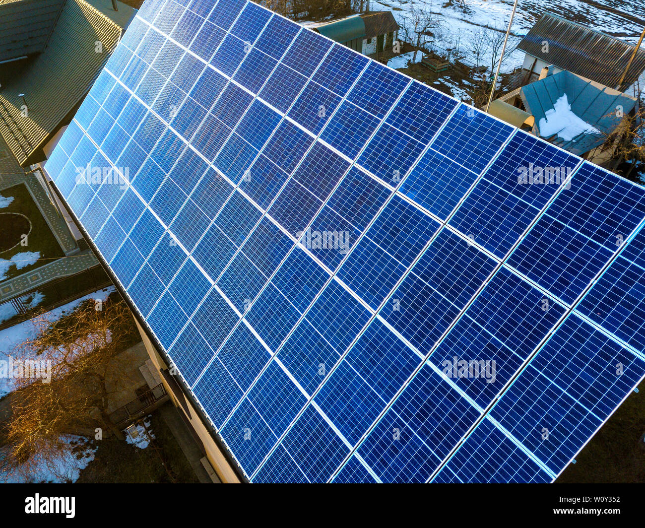 Close-up surface of lit by sun blue shiny solar photo voltaic panels ...