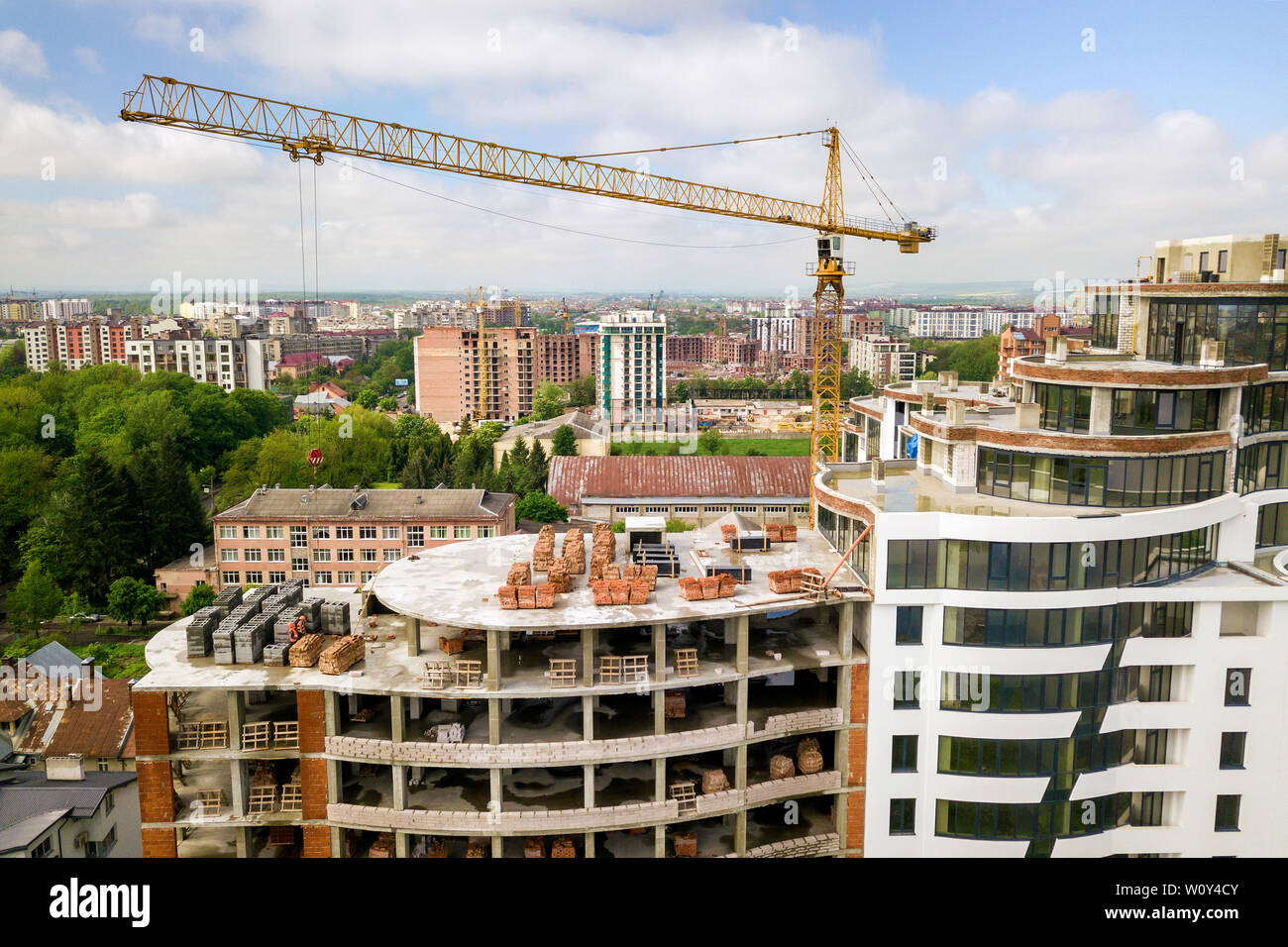 Apartment or office tall building under construction. Brick walls ...