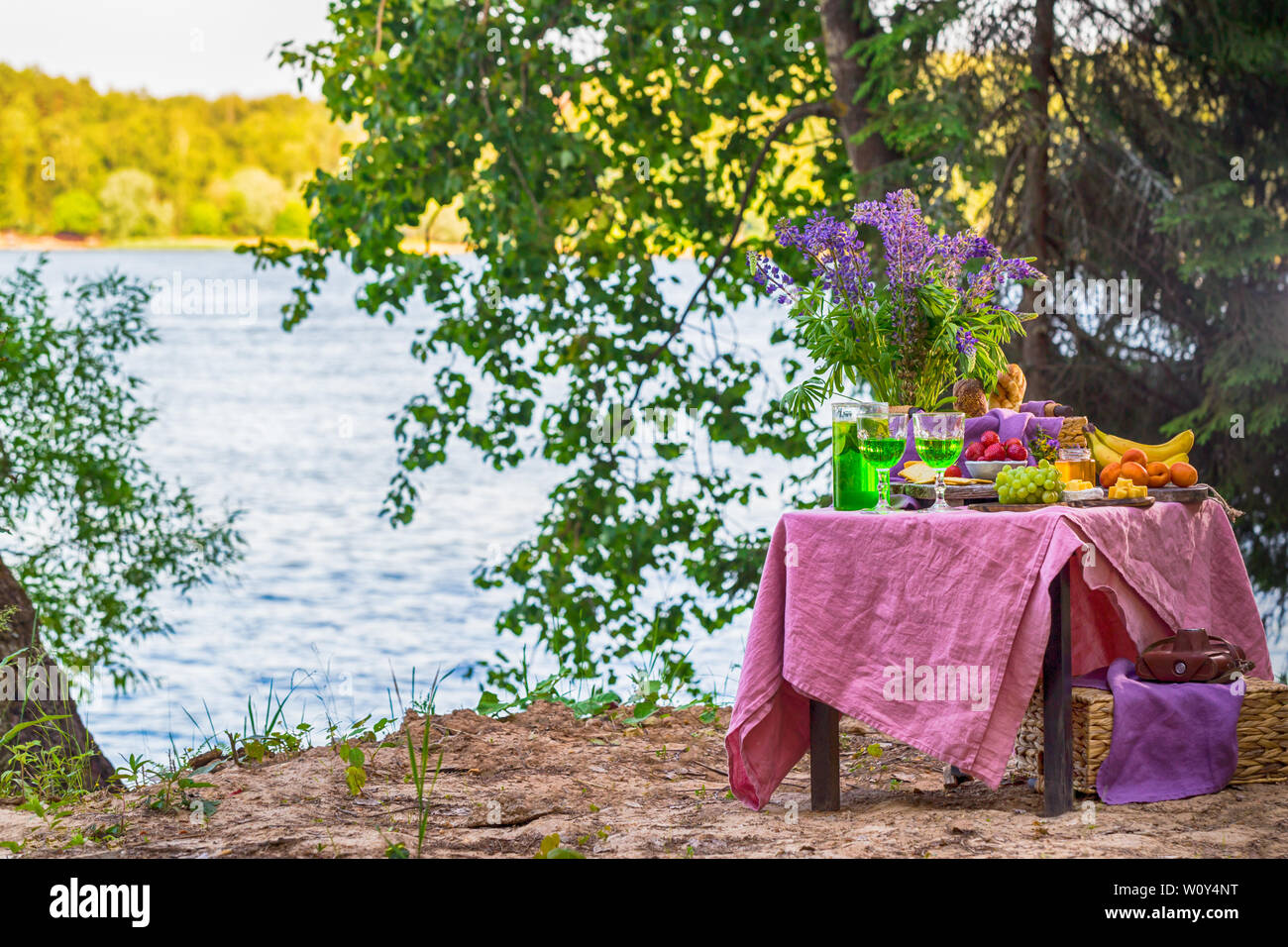 picnic near water at table with flowers in forest different kind of ...