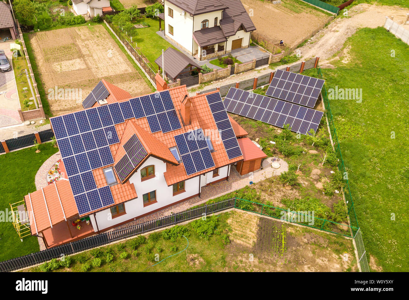 Aerial top view of new modern residential house cottage with blue shiny ...