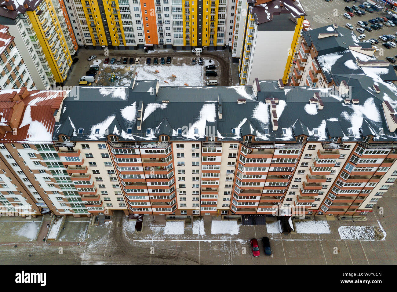 Aerial winter top view of tall apartment building, brick chimneys ...
