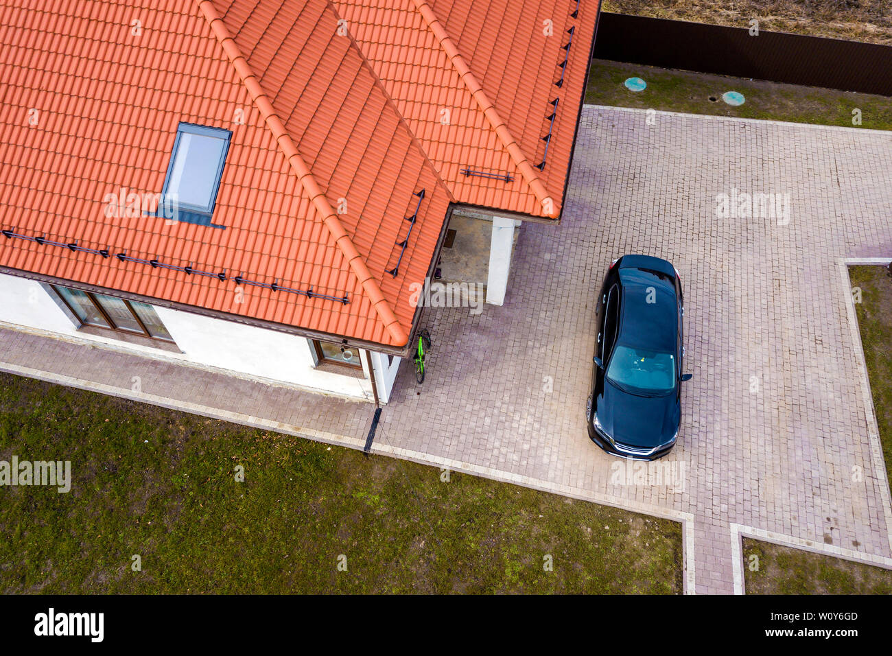 Aerial top view of house metal shingle roof with attic windows and ...