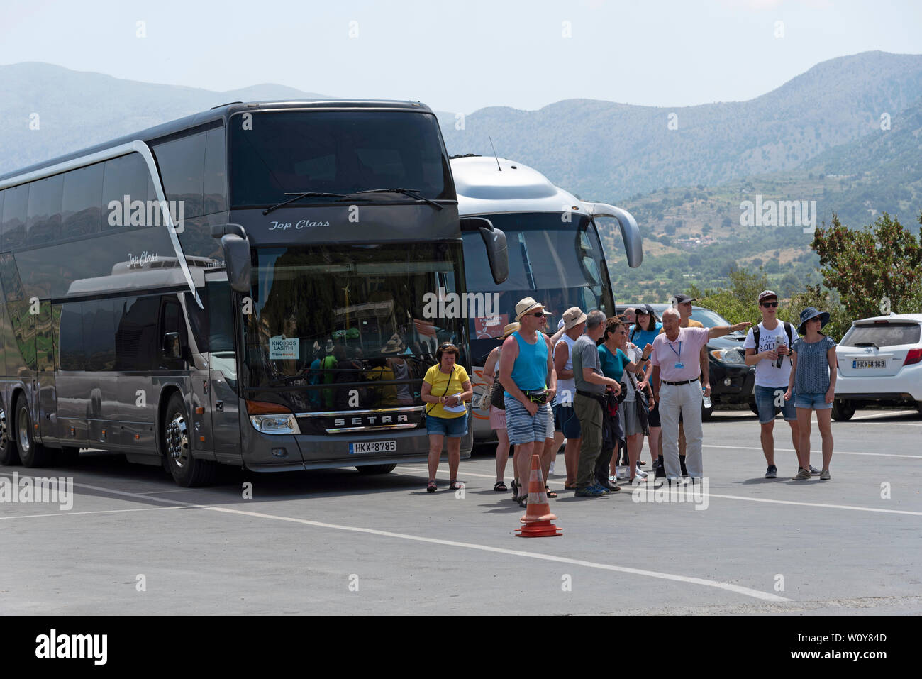 Lassithi, Crete, Greece. June 2019. Tour guide and a group of tourists ...