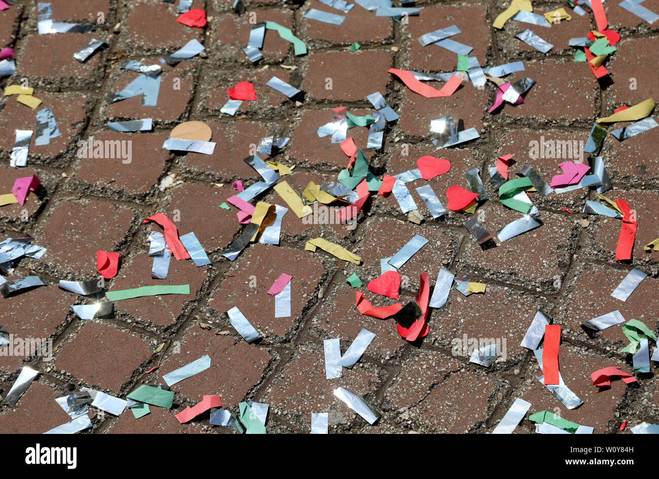 colorful confetti on the asphalt after a Carnival parade Stock Photo ...