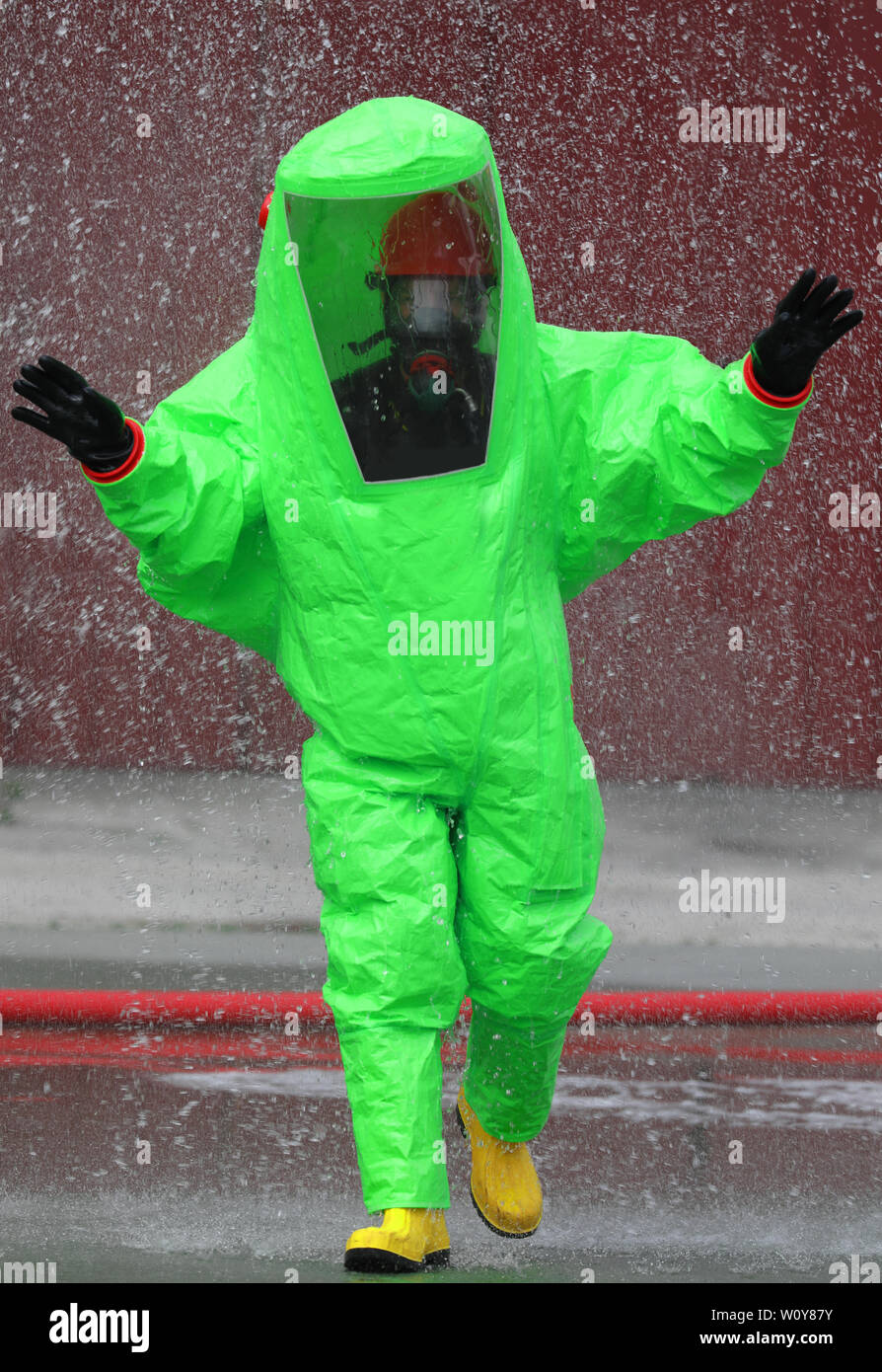 fireman wears a special fluorescent protective suit to extinguish a ...