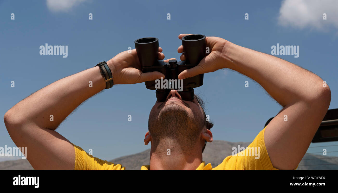 Crete, Greece, June 2019. Tour guide wearing yellow shirt and using a ...