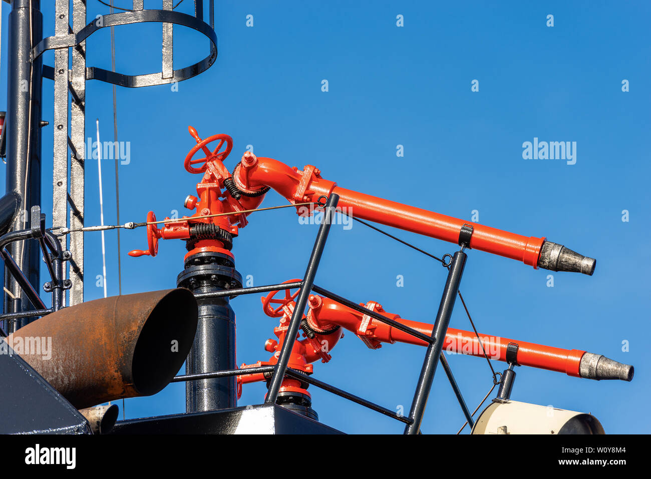 Two red and black water cannons aboard on a fire boat in Italy Stock ...