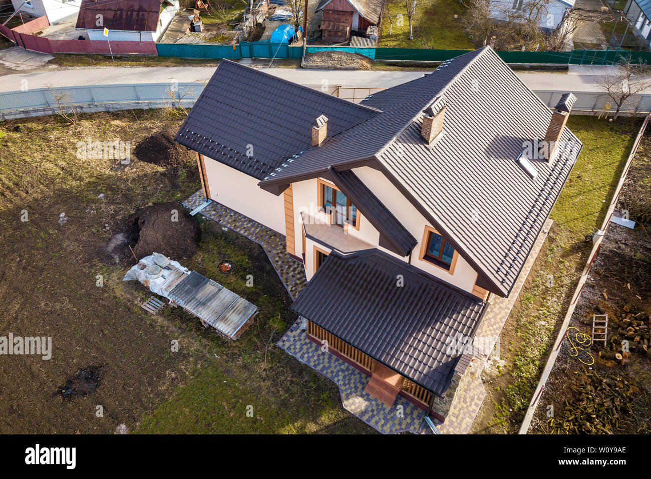 Aerial top view of building steep shingle roof, brick chimneys and ...
