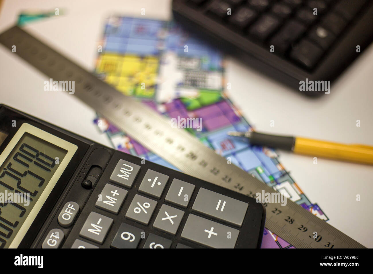 Top view of calculator, pen and ruler on blueprint plan of architecture ...