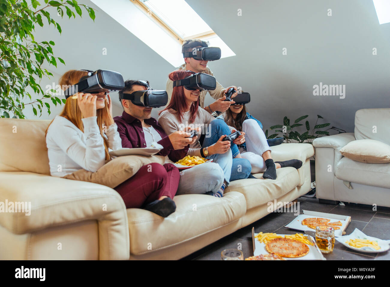 Group of happy friends bonding at home - Young adults having party and ...