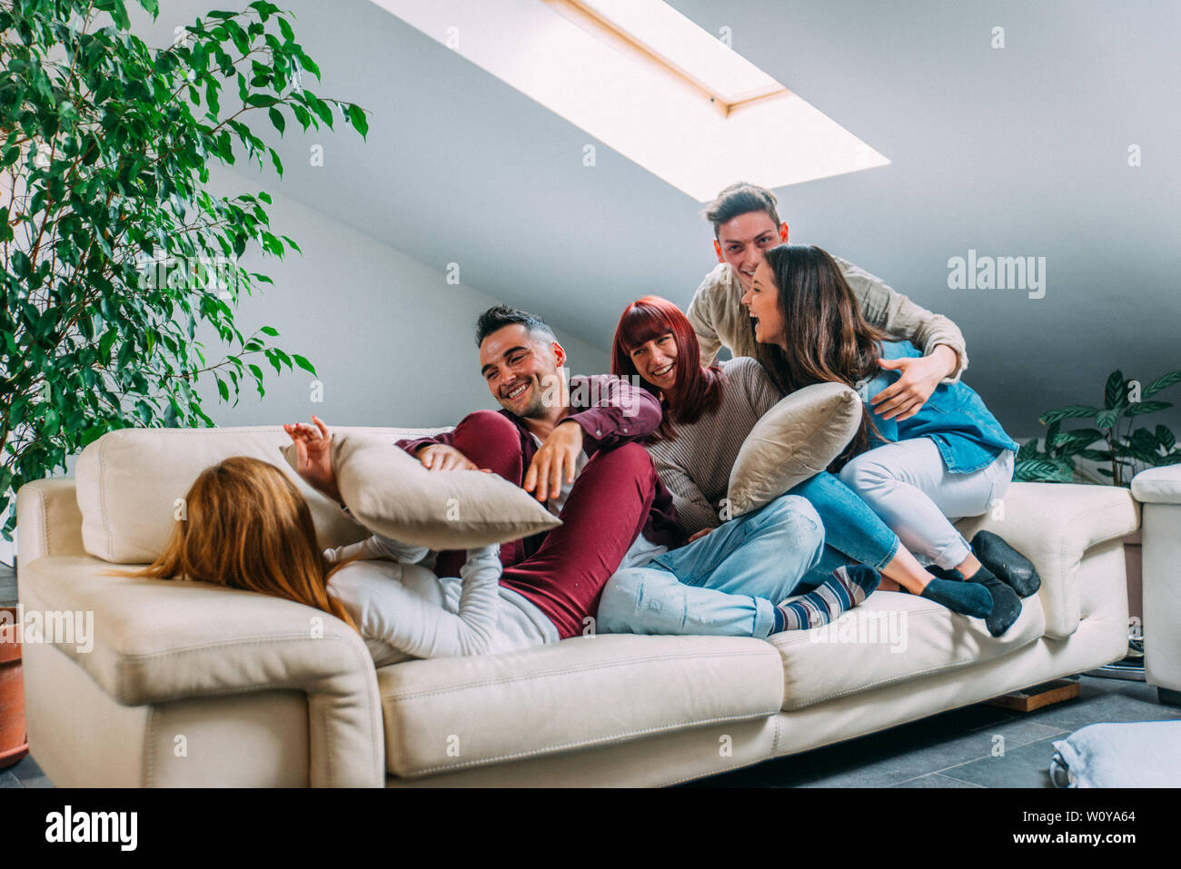 Group of happy friends bonding at home - Young adults having party and ...