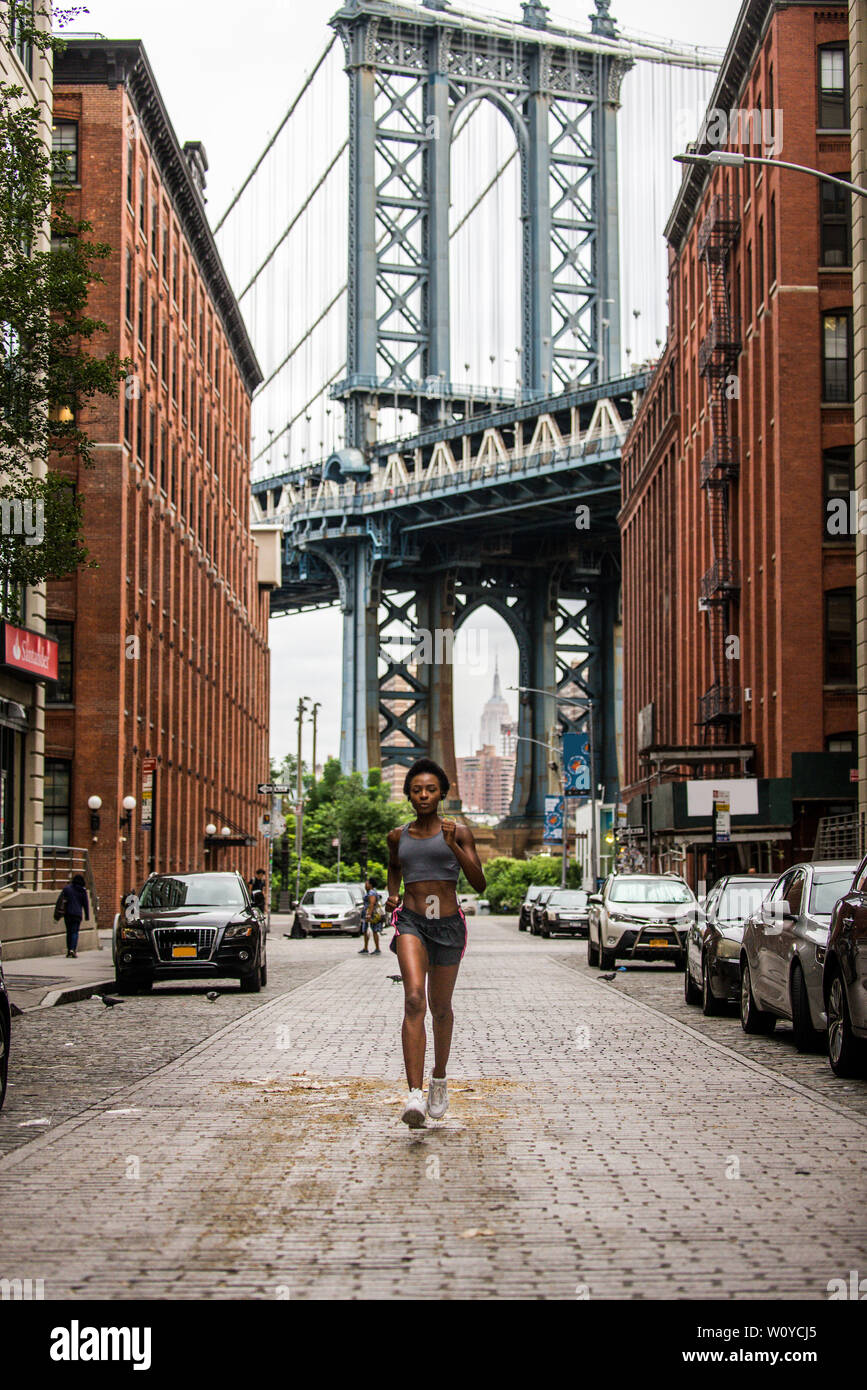 Young fitness woman running in New York - Sportive girl training ...
