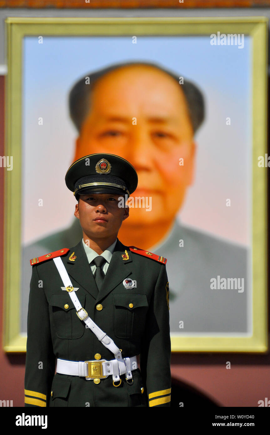 A soldier stands guard over Chairman Mao portrait in Tiananmen Square ...