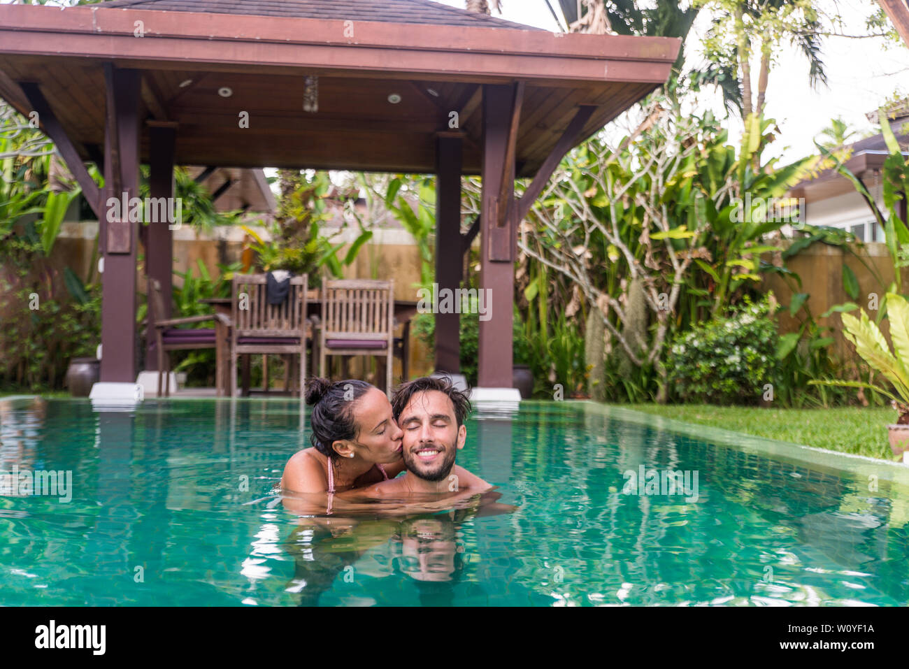 Couple of lovers in a beautiful villa with swimming pool in a tropical ...