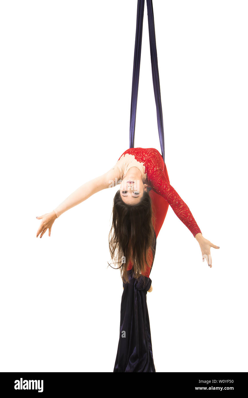 A Young woman with long hair in a red suit performs gymnastic and ...
