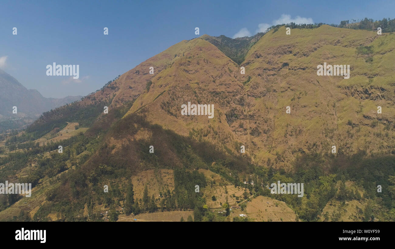mountains with farmlands, village, fields with crops, trees. Aerial ...