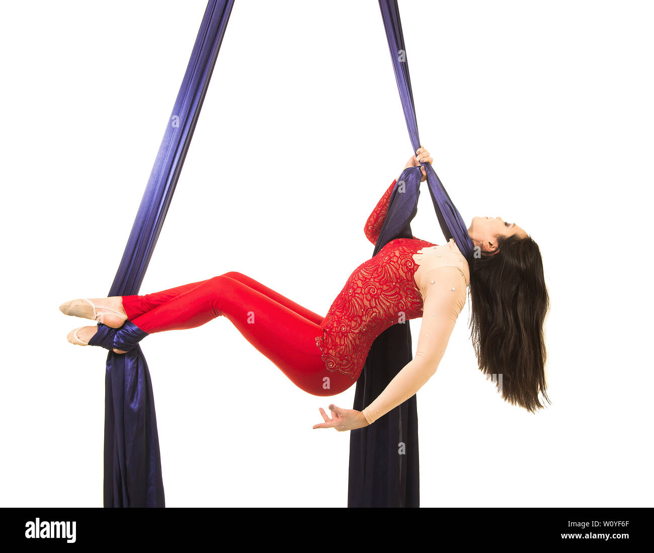 A Young woman with long hair in a red suit performs gymnastic and ...
