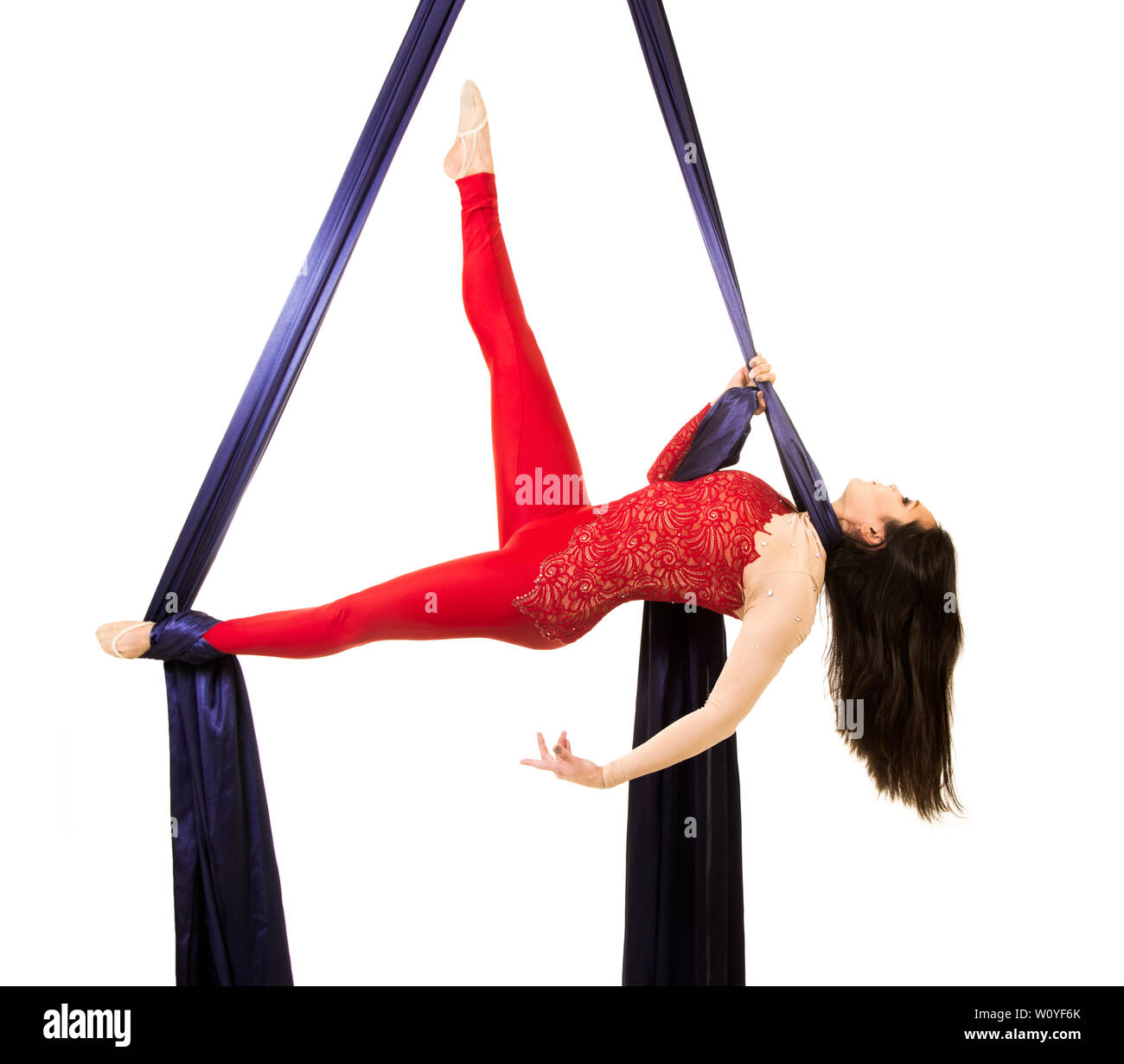 A Young woman with long hair in a red suit performs gymnastic and ...