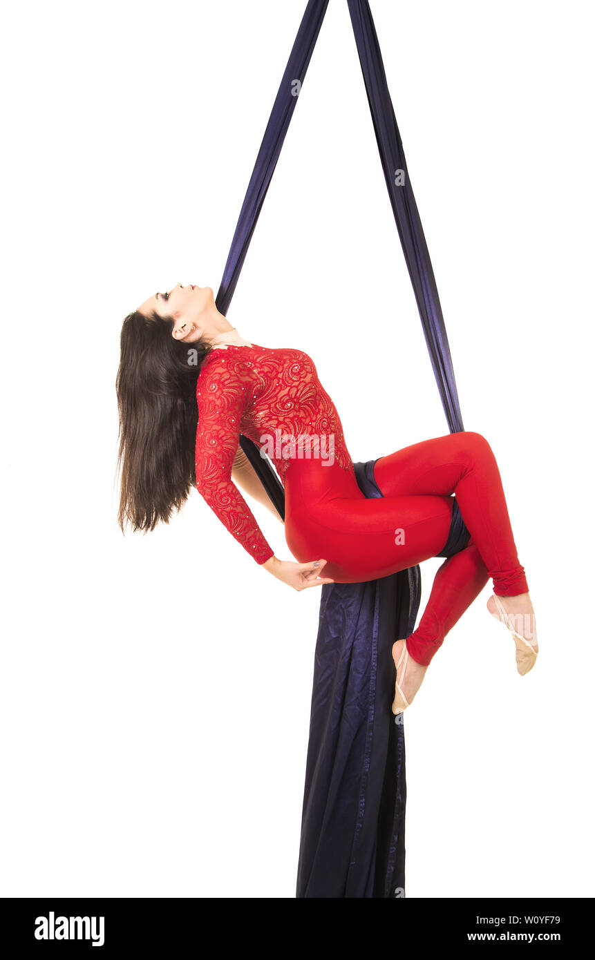 A Young woman with long hair in a red suit performs gymnastic and ...