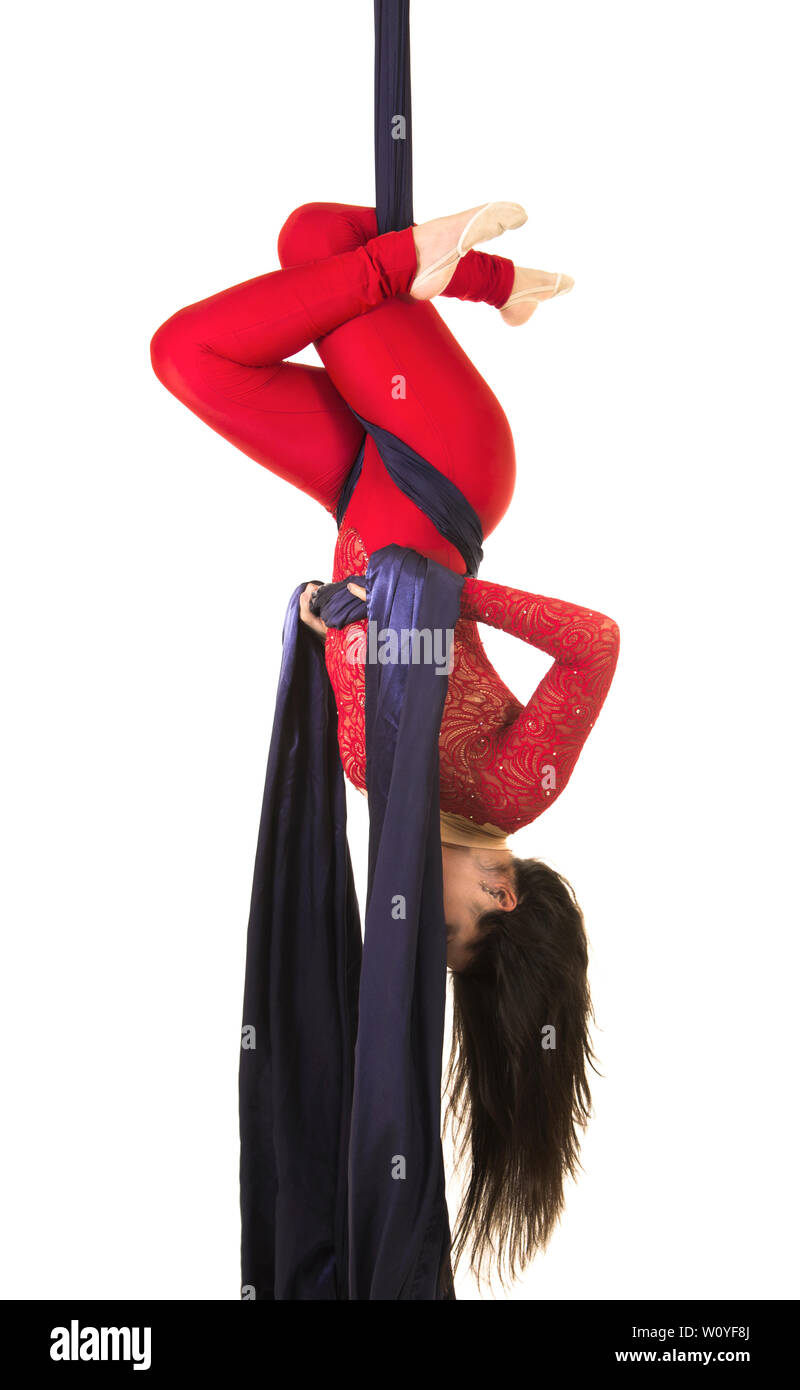 A Young woman with long hair in a red suit performs gymnastic and ...