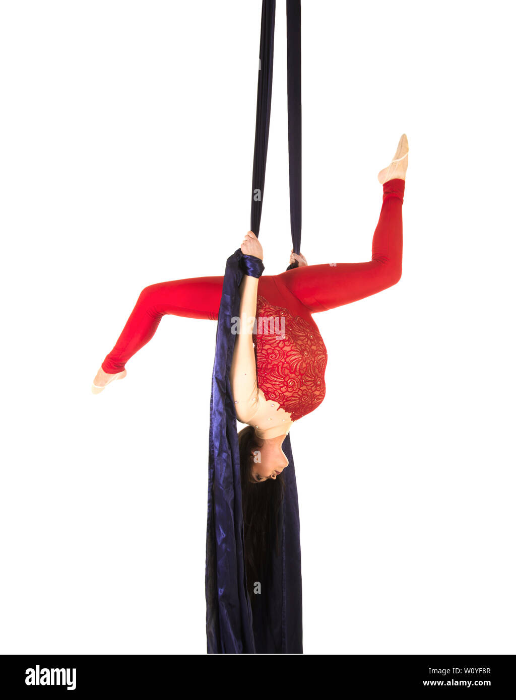 A Young woman with long hair in a red suit performs gymnastic and ...