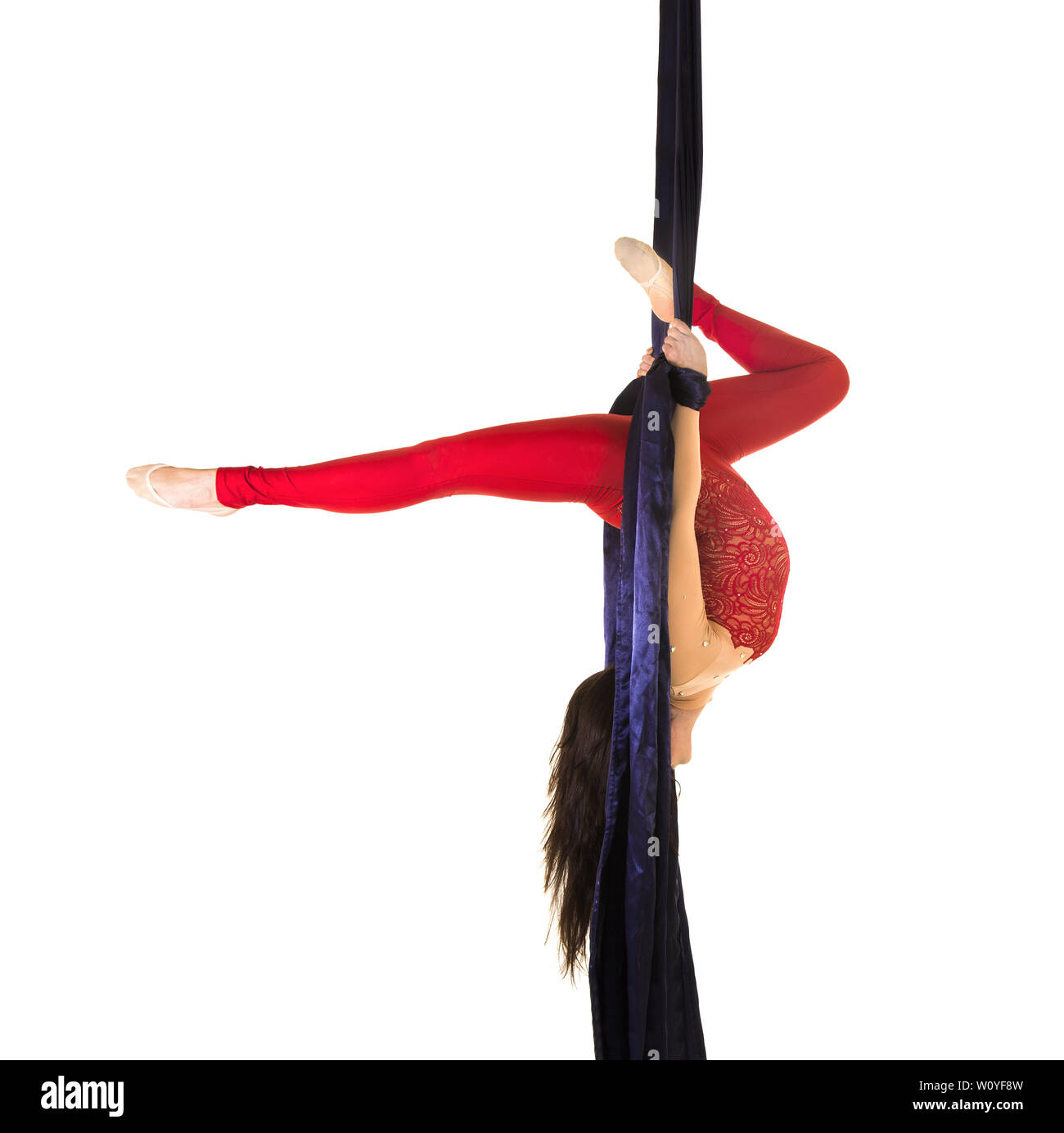 A Young woman with long hair in a red suit performs gymnastic and ...