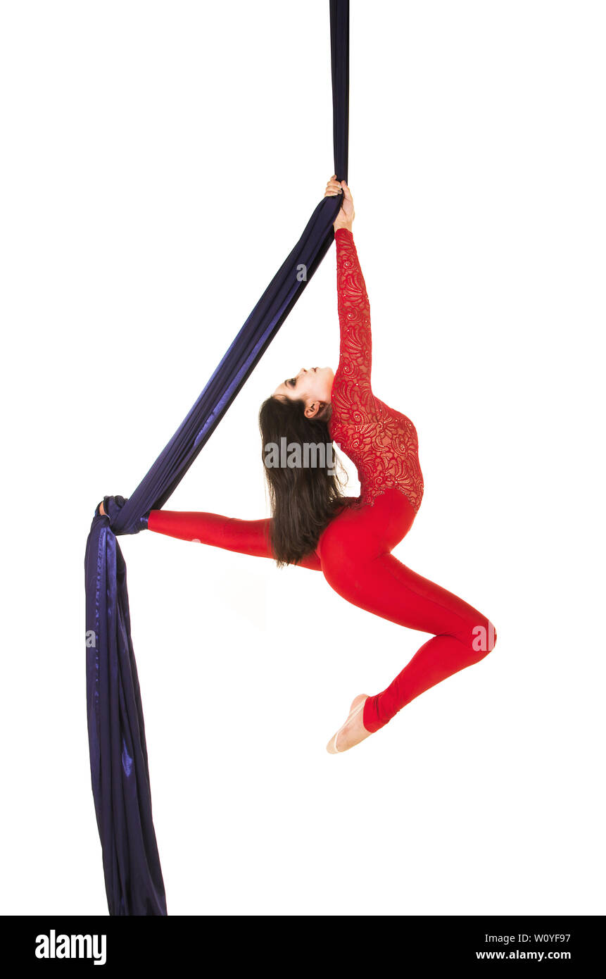A Young woman with long hair in a red suit performs gymnastic and ...