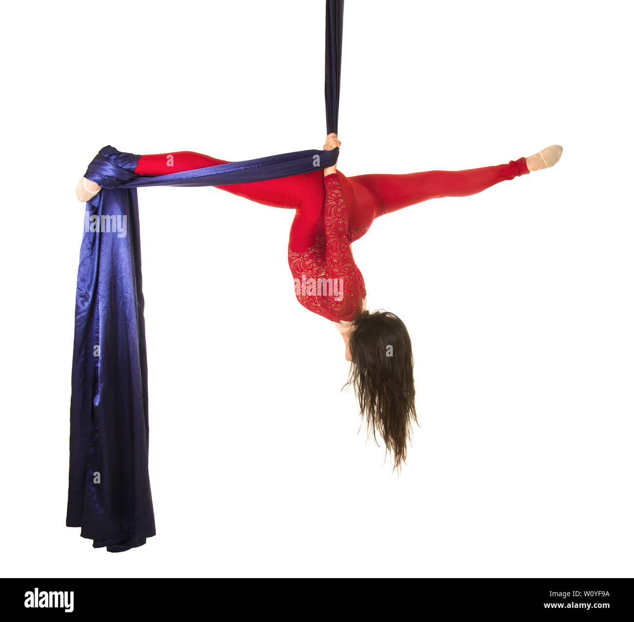 A Young woman with long hair in a red suit performs gymnastic and ...