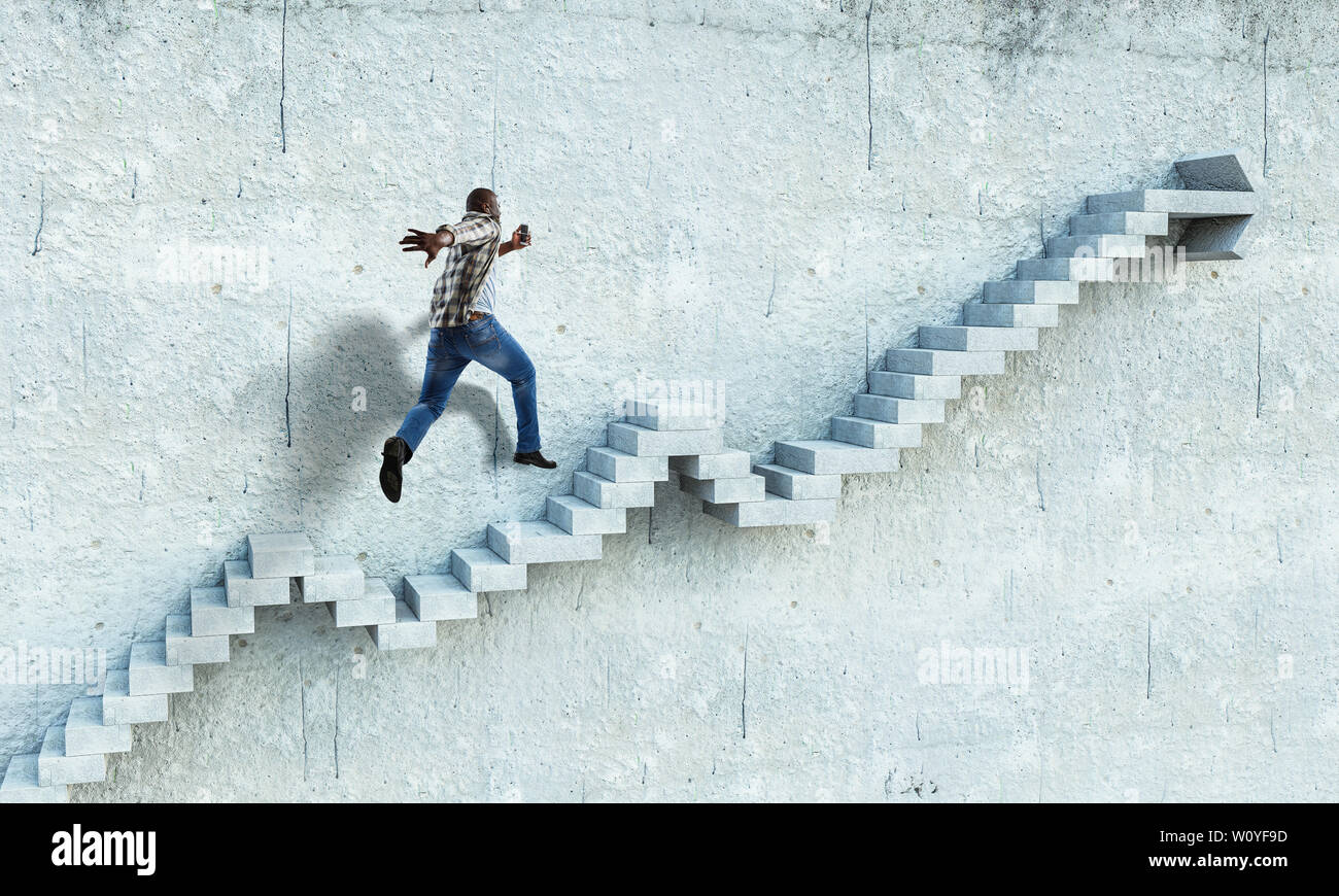 Side view of a black businessman climbing stone stairs illustrating ...