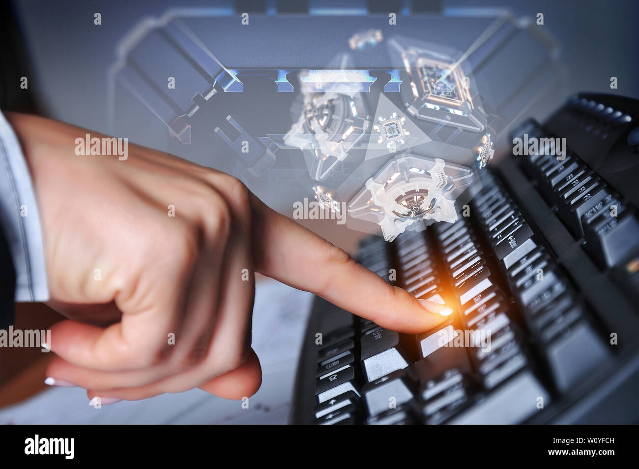 Young businesswoman hands on computer keyboard on tech background with ...