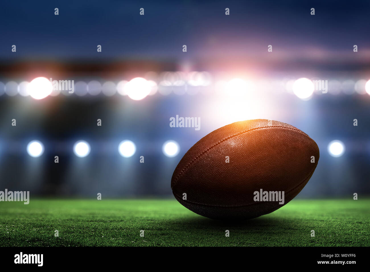 Night football arena in lights and flashes with american football ball ...