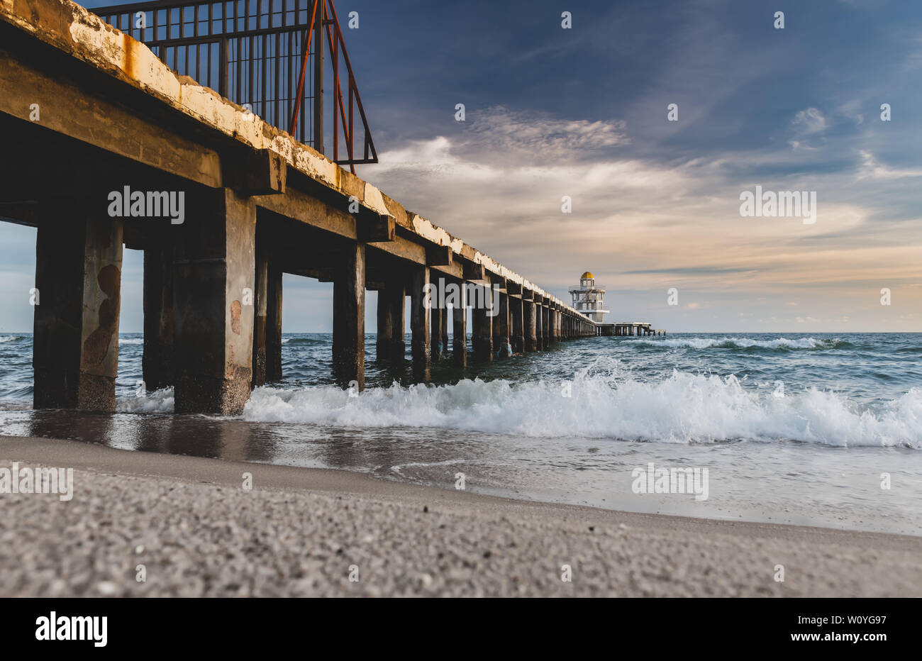 Cement walking bridge in the beach to the sea with outdoor cloud ...
